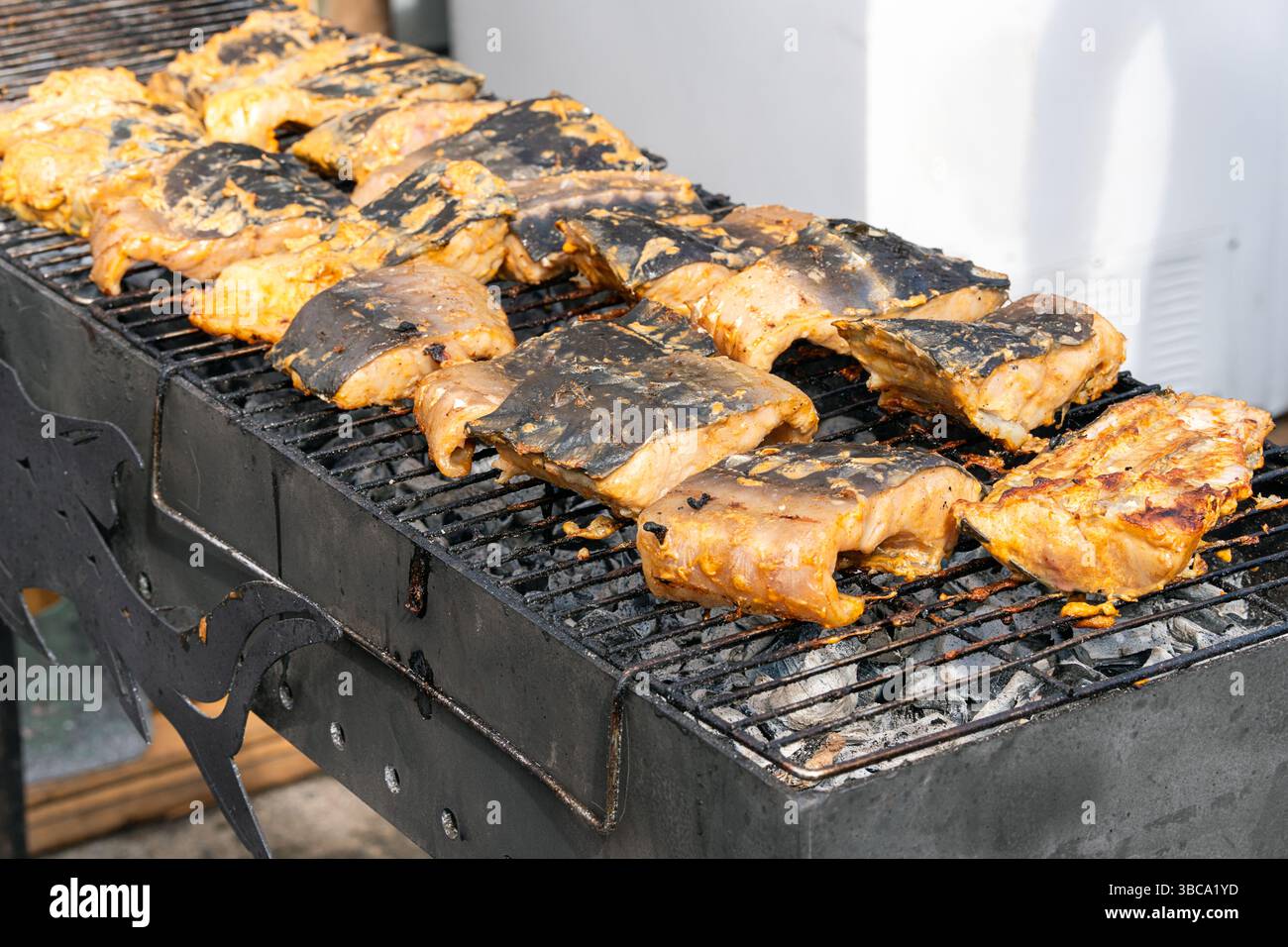 Cooking BBQ Fish. Grilled sturgeon on a charcoal grill. Picnic in the ...