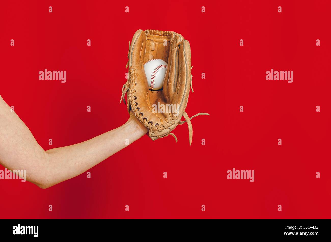Female baseball gloved hand catches ball on red. Active baseball sport ...