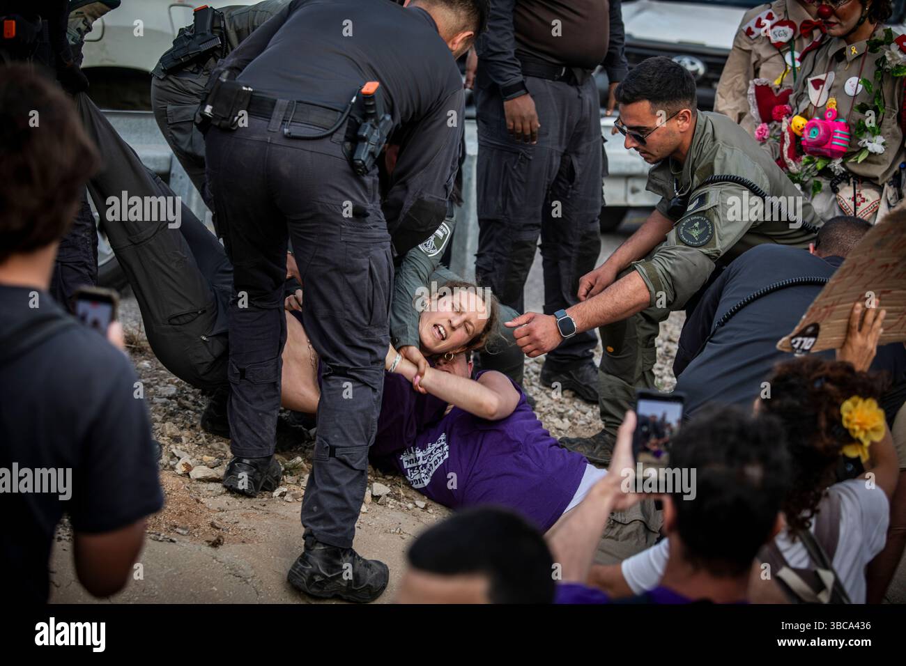 Israeli police officers pull a protestor during an anti war ...
