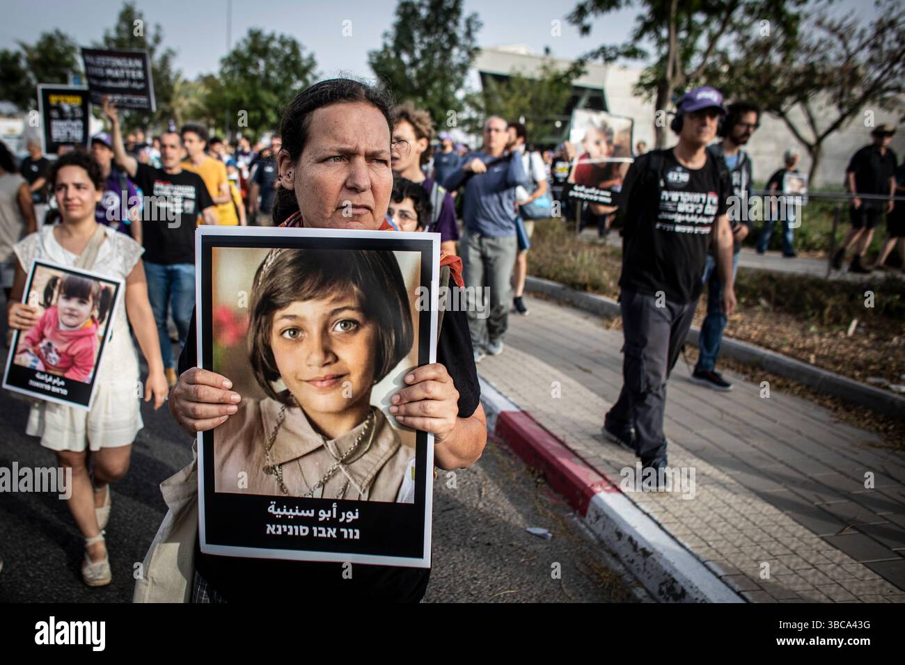 An Israeli Peace activist caries a placard showing dead Palestinian ...