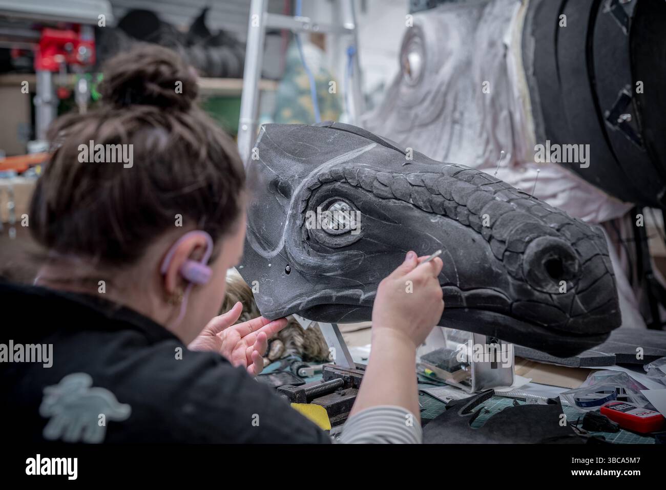 Farnham, Surrey, UK. 19th May, 2025. Joint studio head: Chuck Brown works on a creature head ...