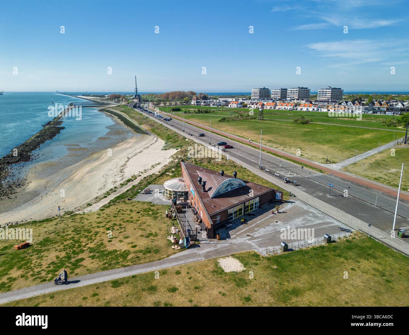 A coastal view showing a quiet seaside town with a rocky shoreline ...