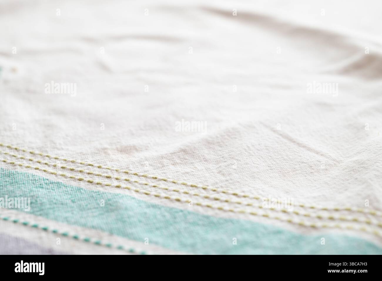 White and green striped linen fabric showing texture and stitching ...