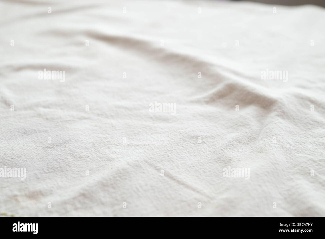 White linen fabric texture background with soft folds and wrinkles ...