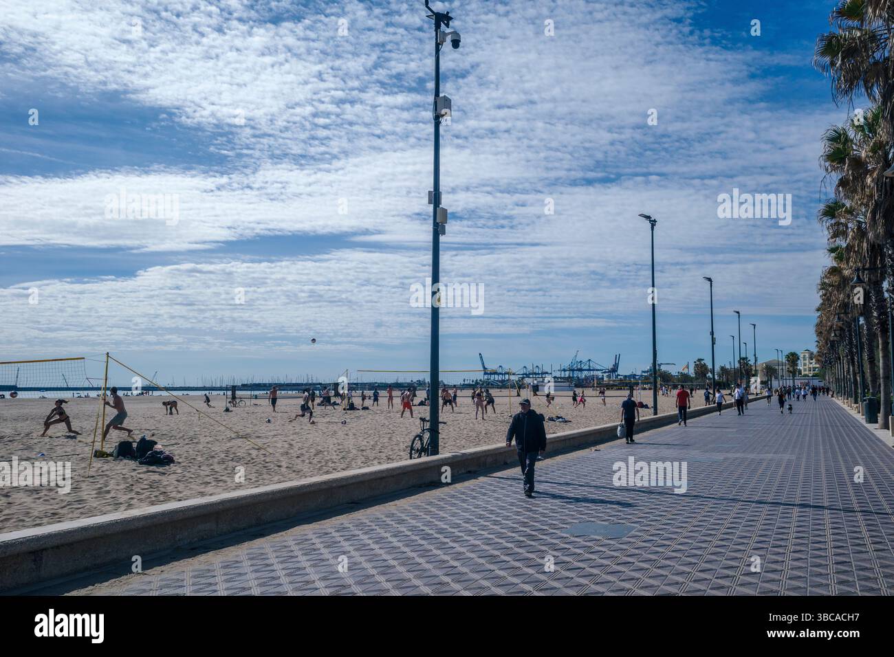 Young and old people playing and strolling along the promenade of Las ...