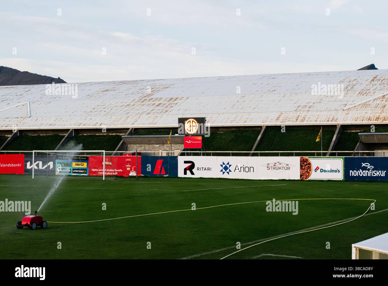 Akranes, Iceland - May 16, 2025: Sprinklers water a football field ...