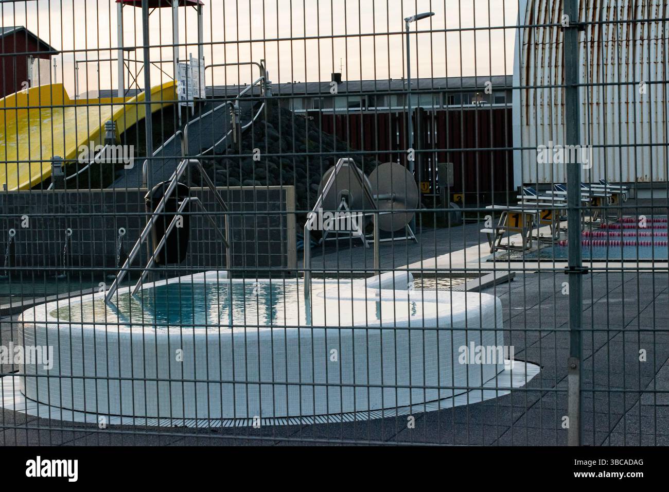 Akranes, Iceland - May 16, 2025: An outdoor pool with slide and hot tub ...