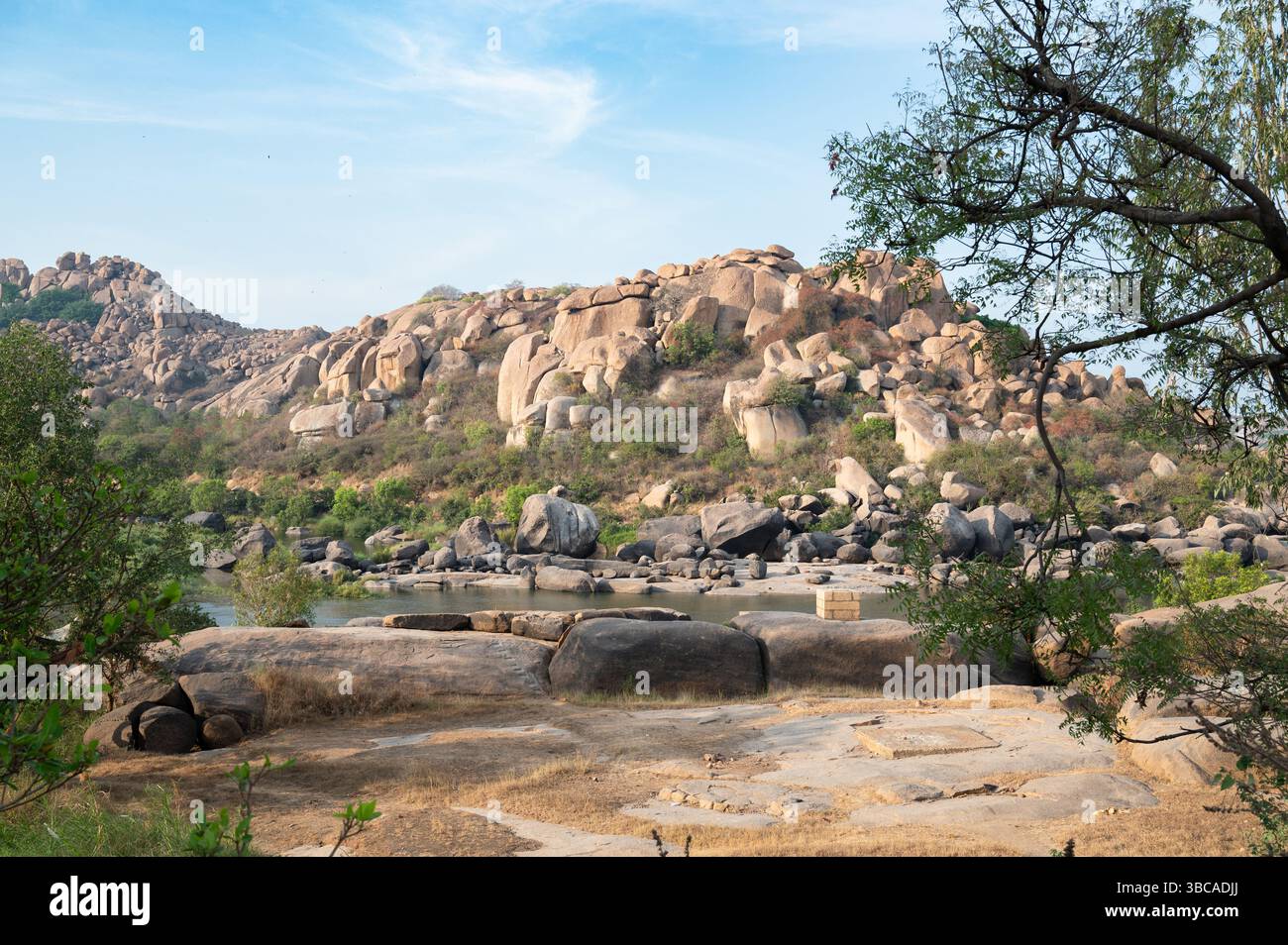 Tungabhadra river with boulders in Hampi, rocky terrain landscape ...