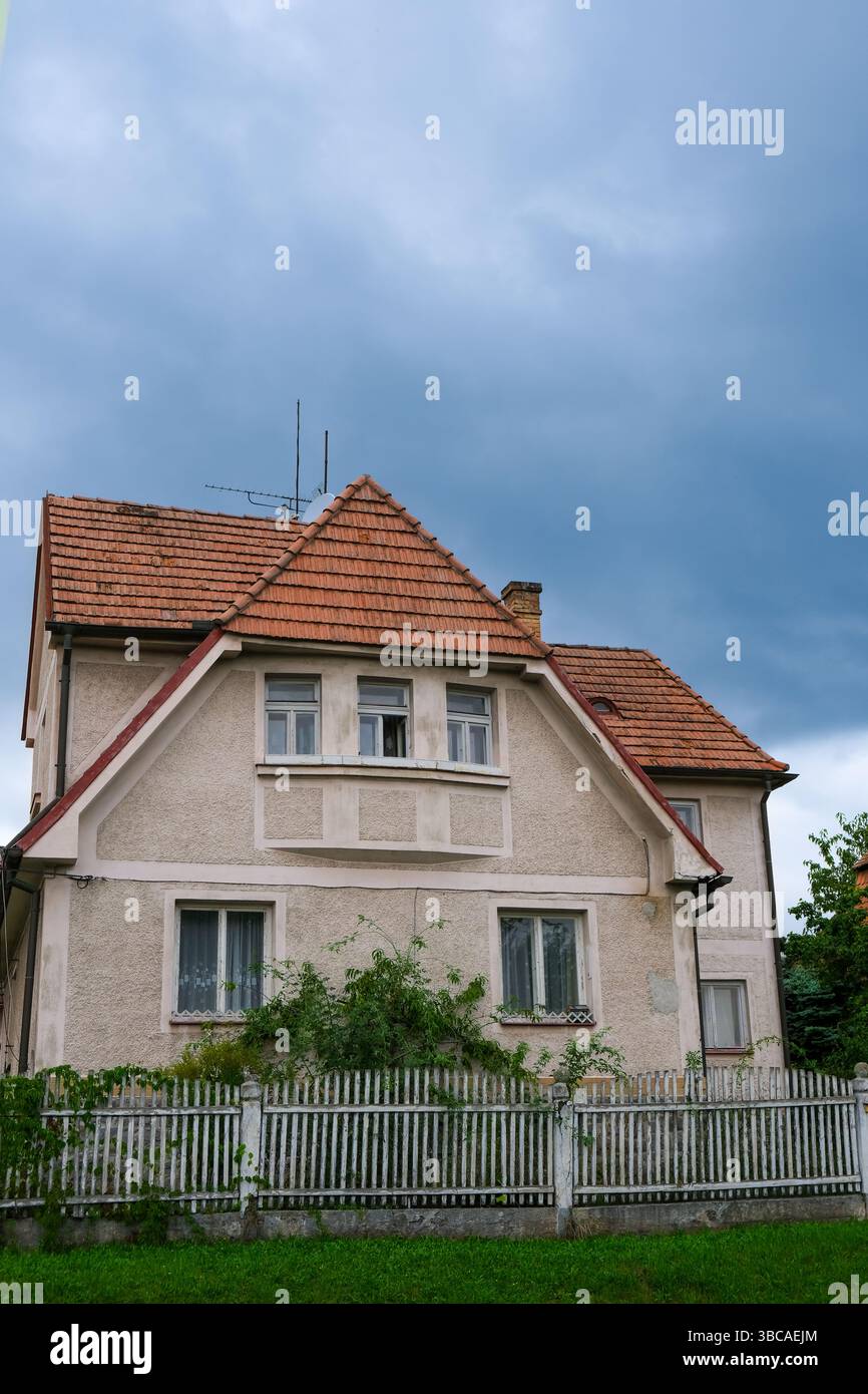 Old house with tiled roof and cloudy sky Stock Photo - Alamy