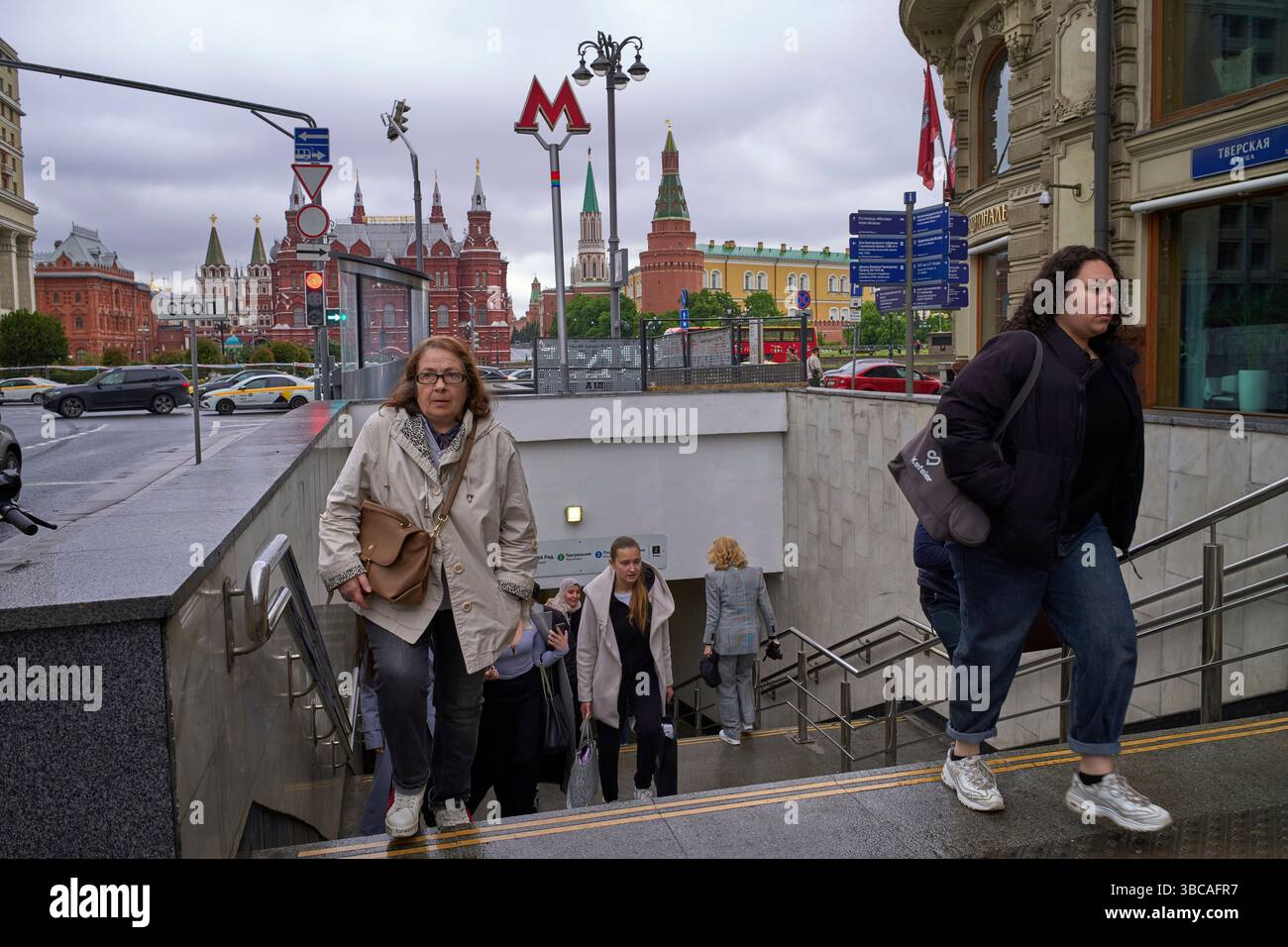 Pedestrians climb stairs from an underground passage near the famous ...