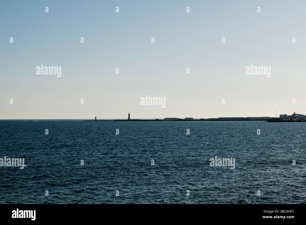 A serene view of Akranes harbor featuring lighthouses and a tranquil ...