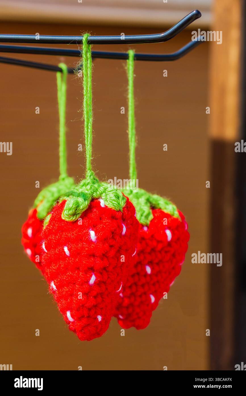 Colorful Crochet Strawberry Ornaments Hanging on a Metal Display Stand ...