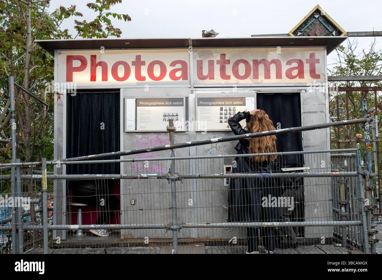 Visitors use a retro-style Photoautomat photobooth in Berlin, Germany ...