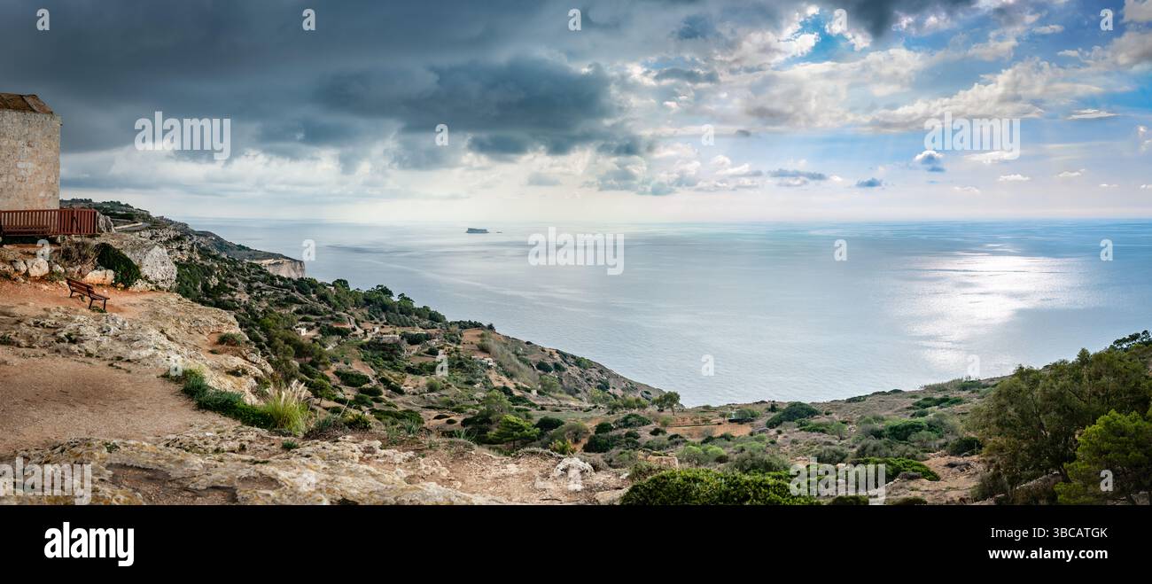 Wooden forged bench on the cliffs with view of sea. Dingli cliff's ...