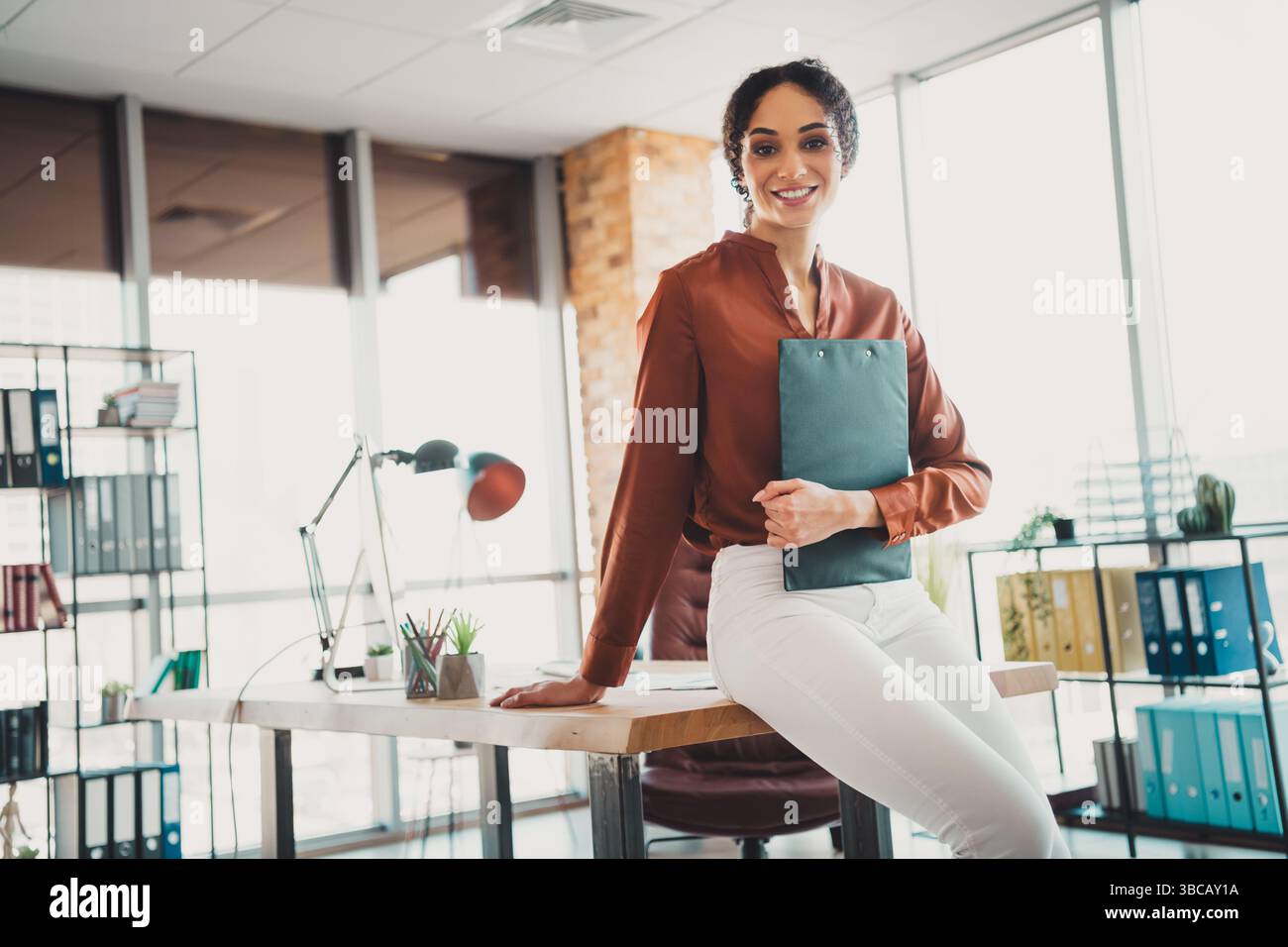 Confident businesswoman in a professional office setting holding a ...
