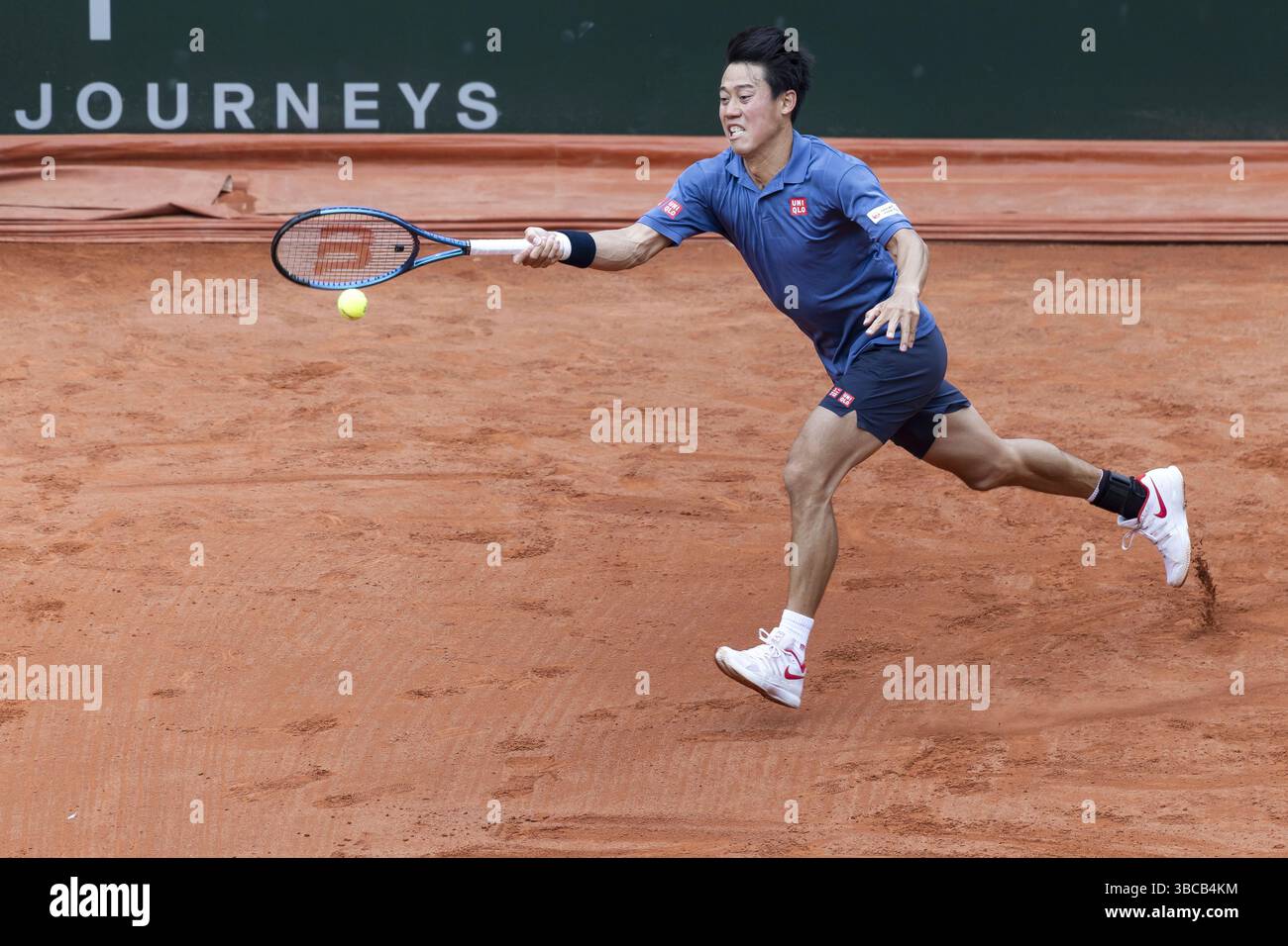 Kei Nishikori of Japan, returns a ball to Learner Tien of the US ...