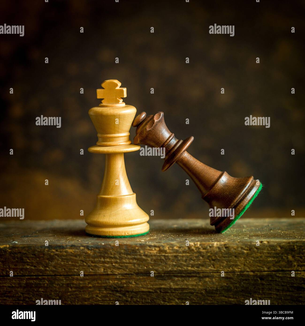 Two intricately designed chess pieces, a golden king and a dark queen ...