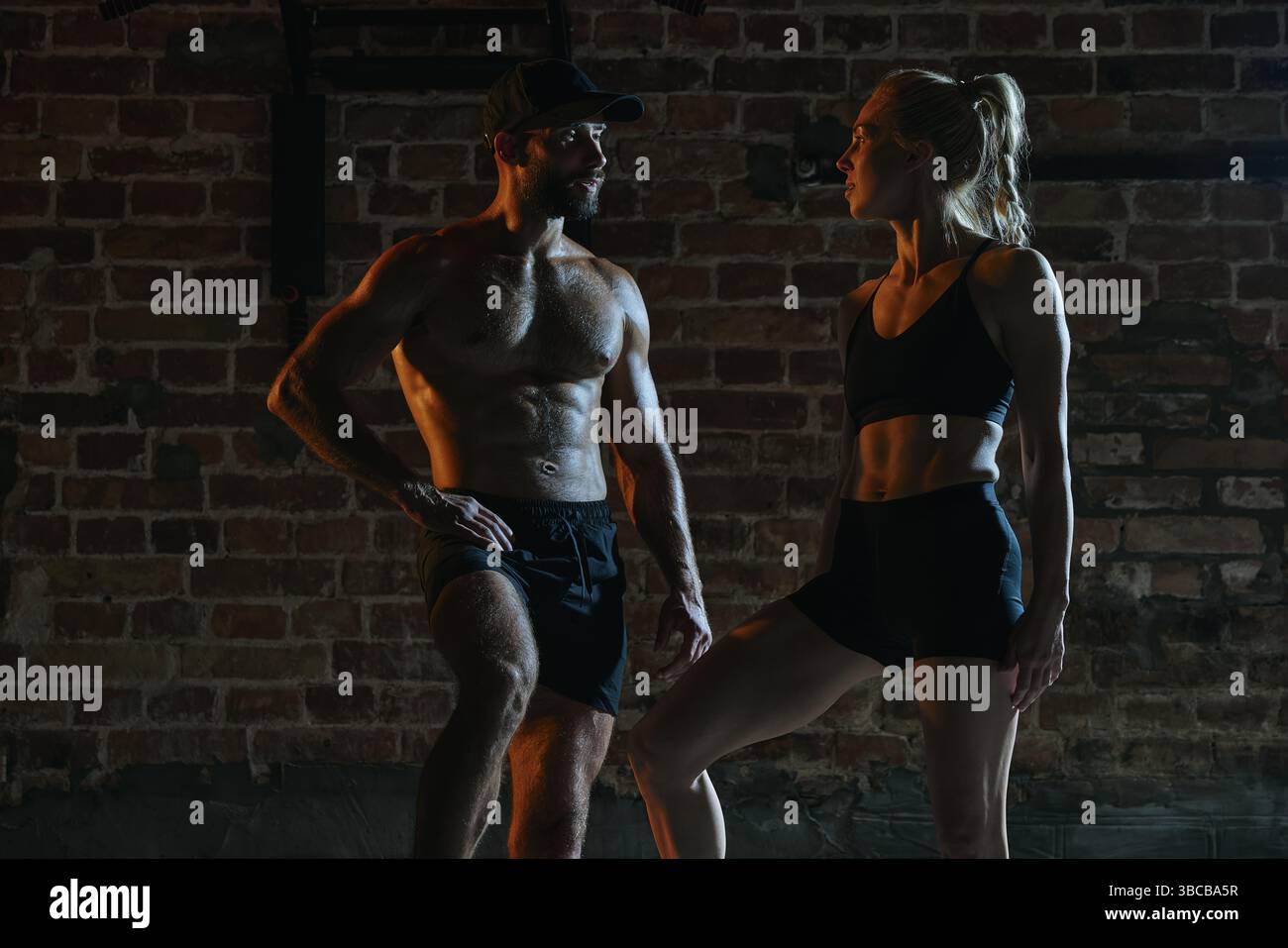 Close up of man and woman in fitness gear locking eyes and standing ...