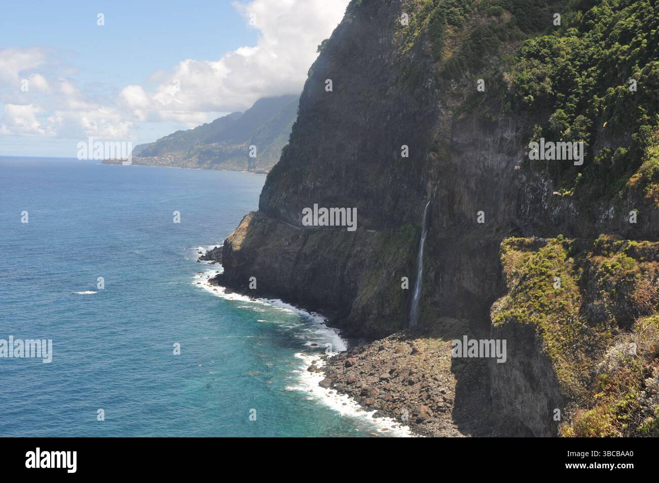 Waterfall from cliffside into ocean Stock Photo - Alamy