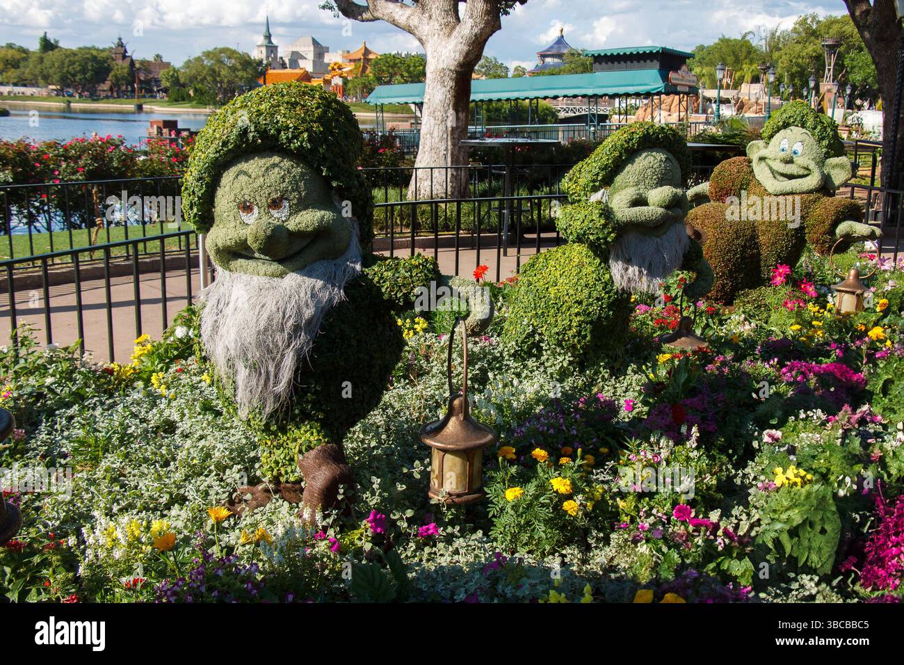 The Snow White dwarfs cartoon characters at the flower and garden ...