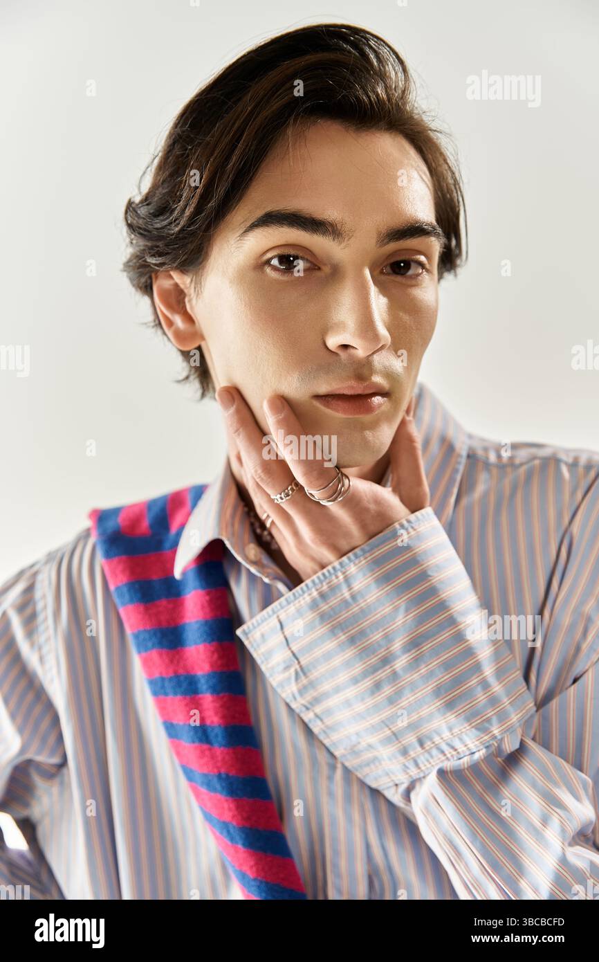 A stylish young non binary person poses confidently while expressing ...