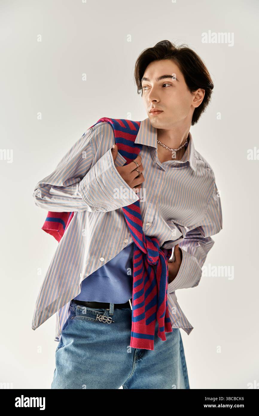 A young non binary person showcases individual style in a trendy outfit ...