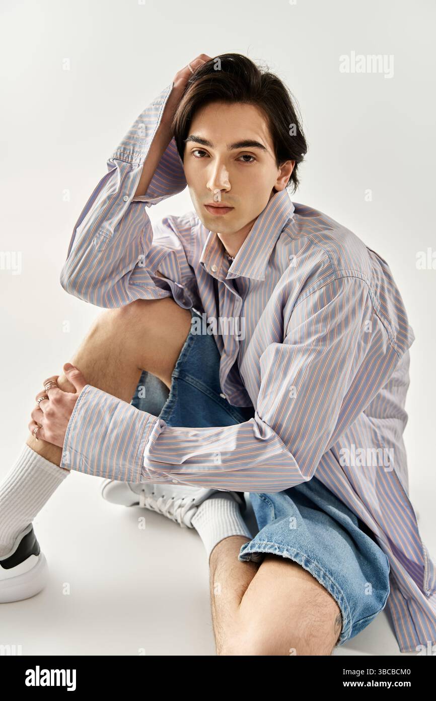 Stylish young person showcases modern fashion trends while seated in a ...