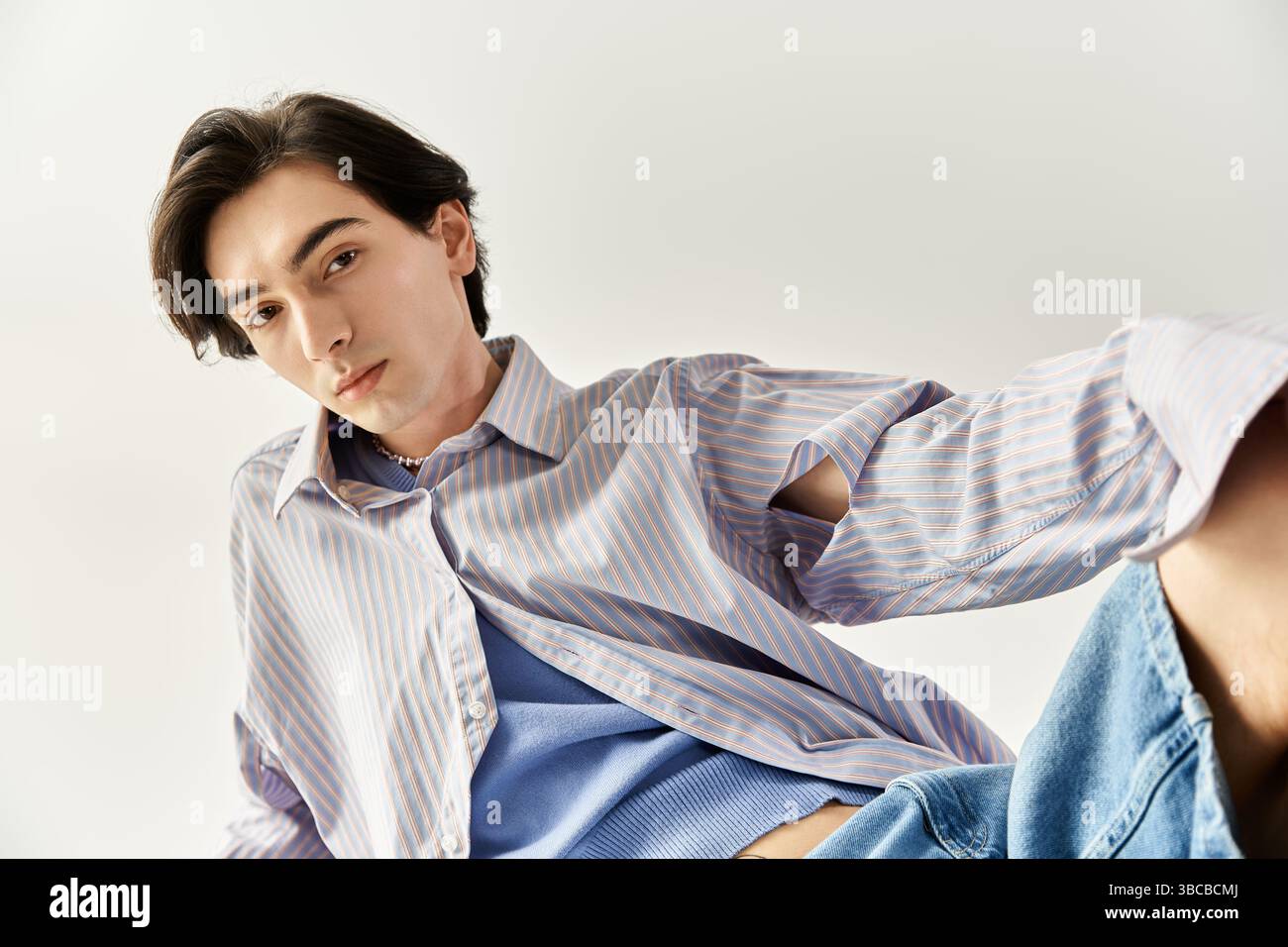 Fashionable non binary individual poses confidently, celebrating unique ...