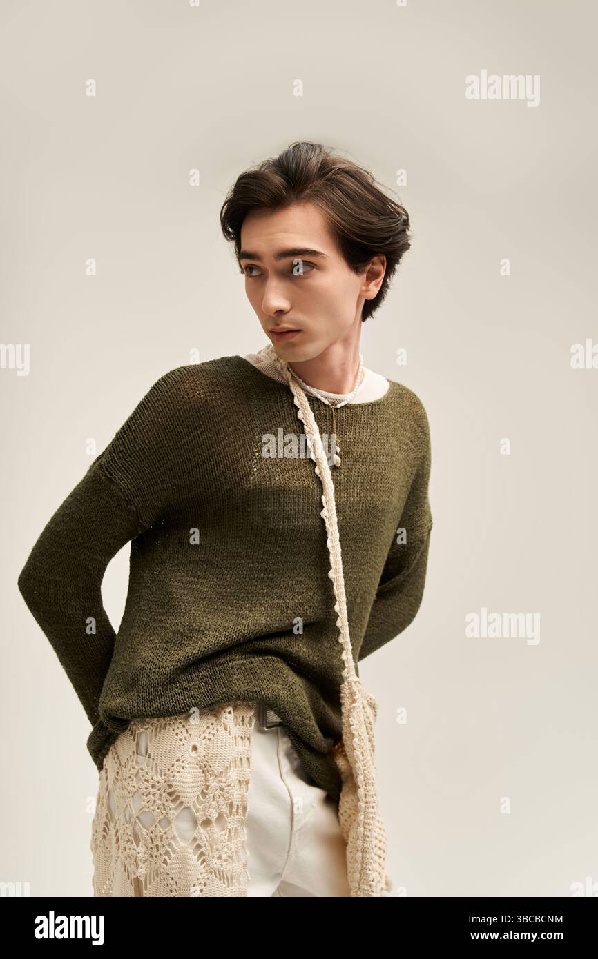 Non binary individual showcases unique fashion in a minimalist studio ...