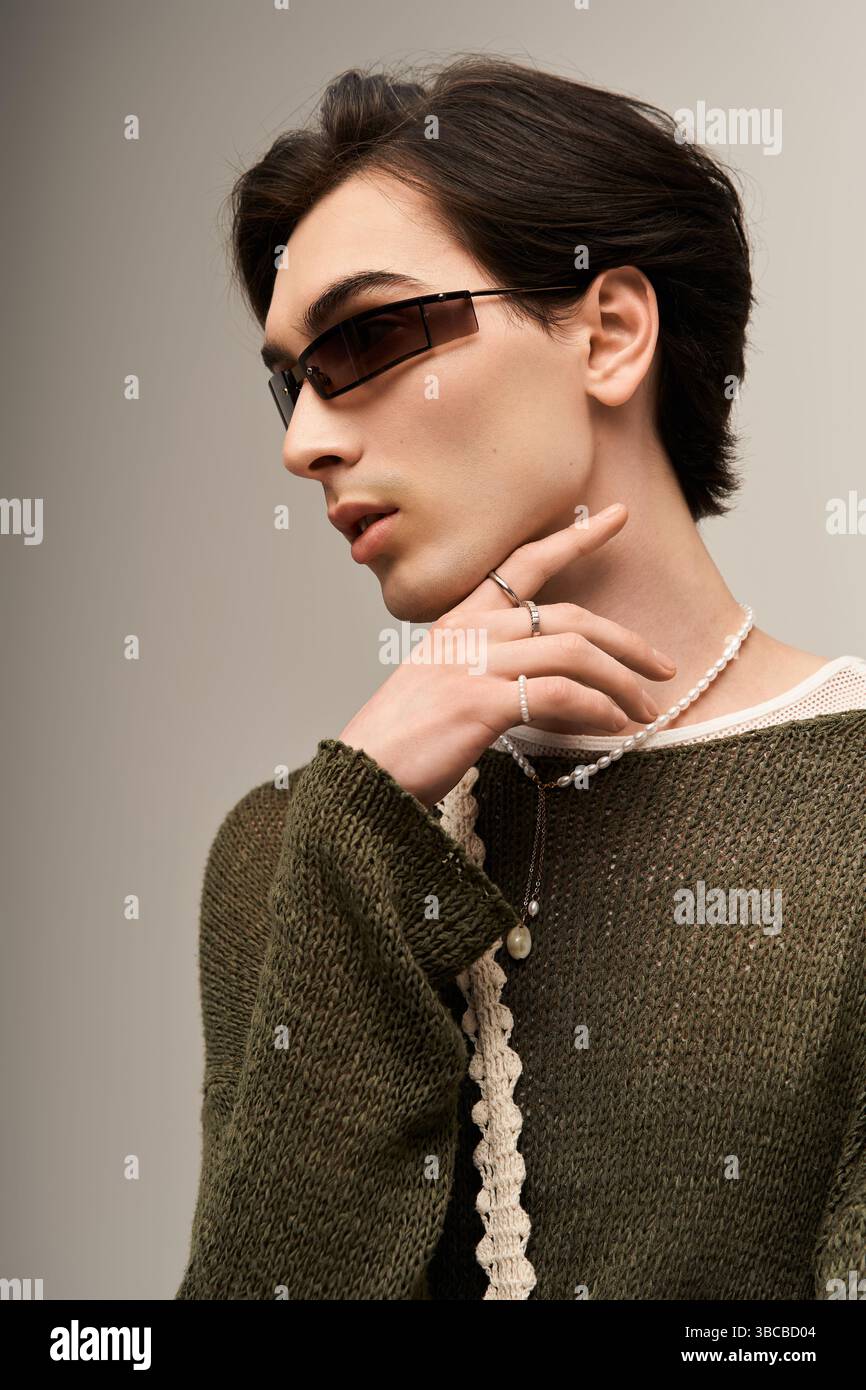 A stylish non-binary individual confidently showcases their fashion in a chic urban setting ...