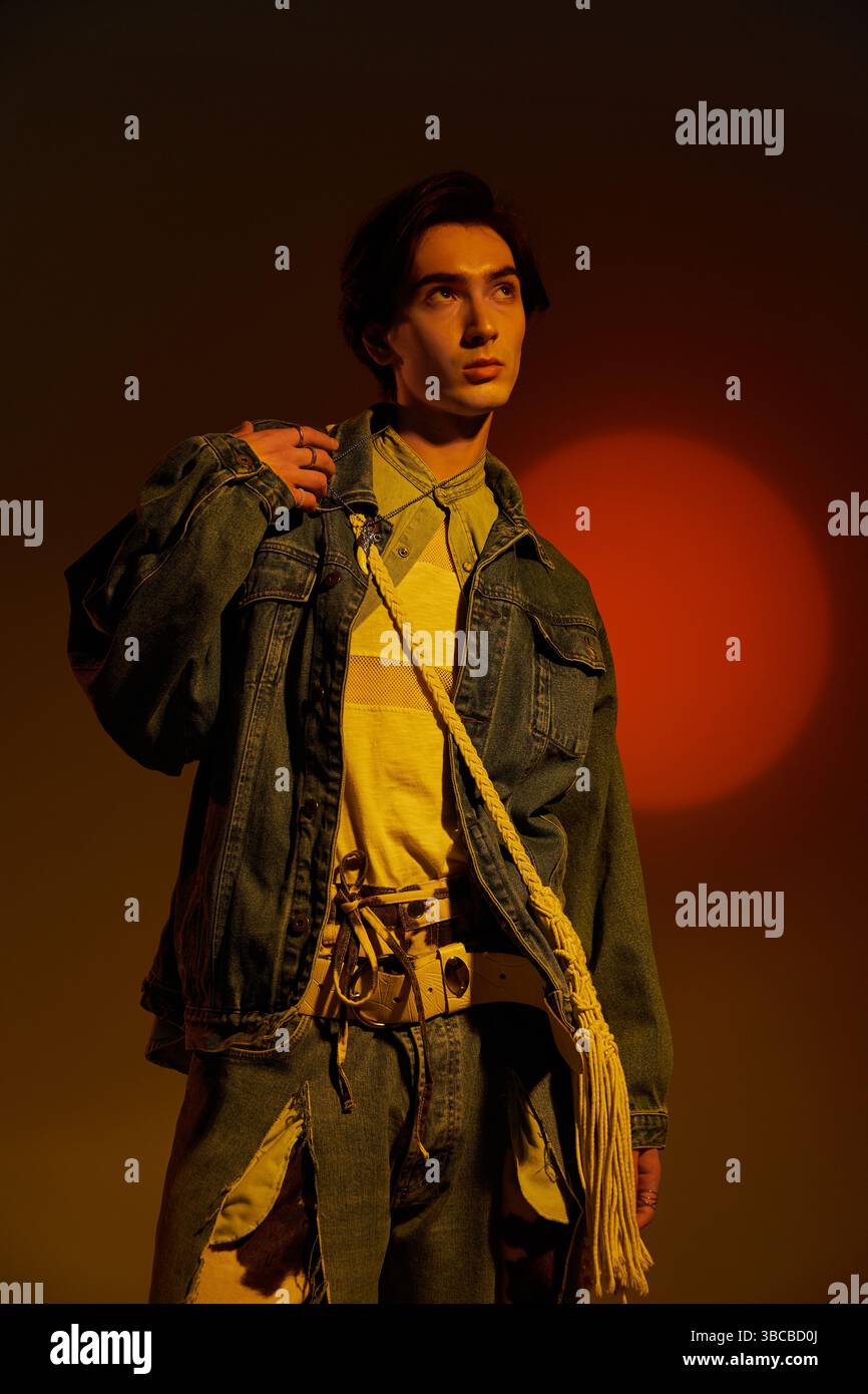 A stylish young non binary individual showcases their fashion sense under a vibrant sunset Stock ...