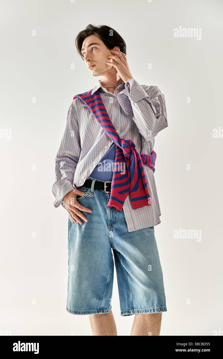 A young fashionable non binary person showcases unique style with ...