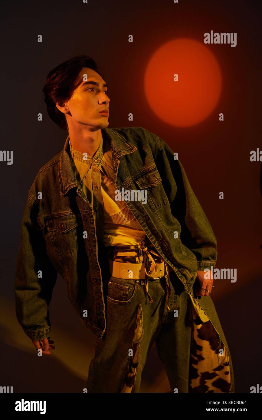 A stylish young non binary person showcases unique fashion in front of ...