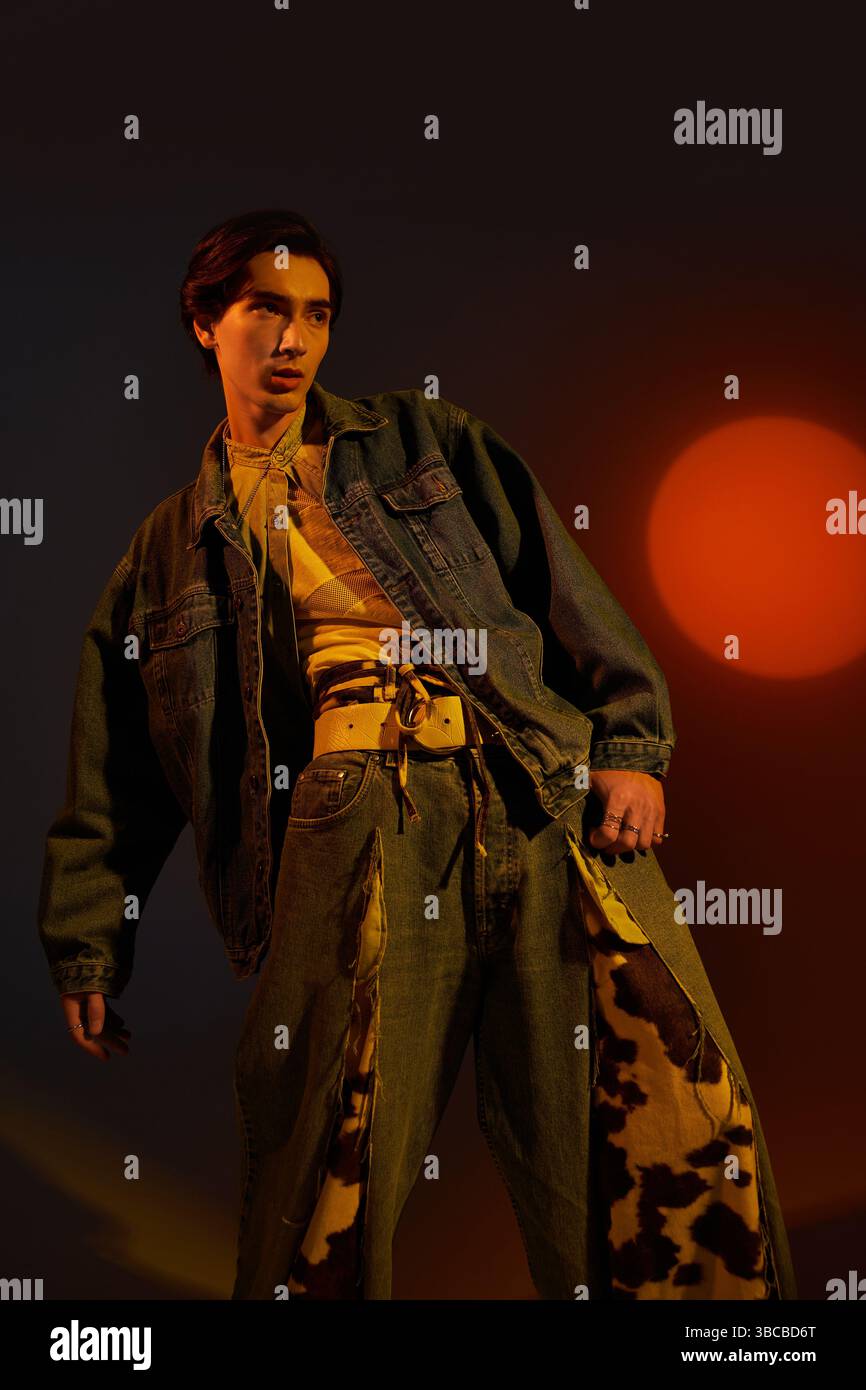 A young non binary person showcases unique fashion against a vibrant ...