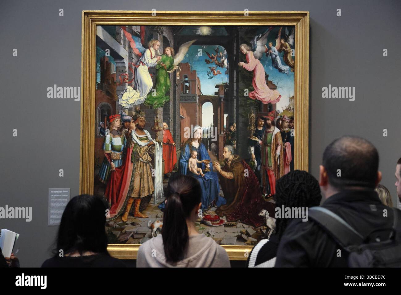 Visitors studying the painting The Adoration of the Kings by Flemish ...