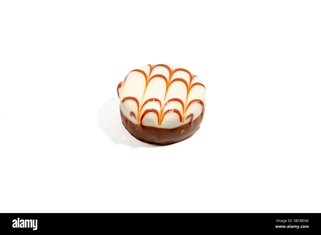 Round praline with a mesh pattern on a white background. This praline ...