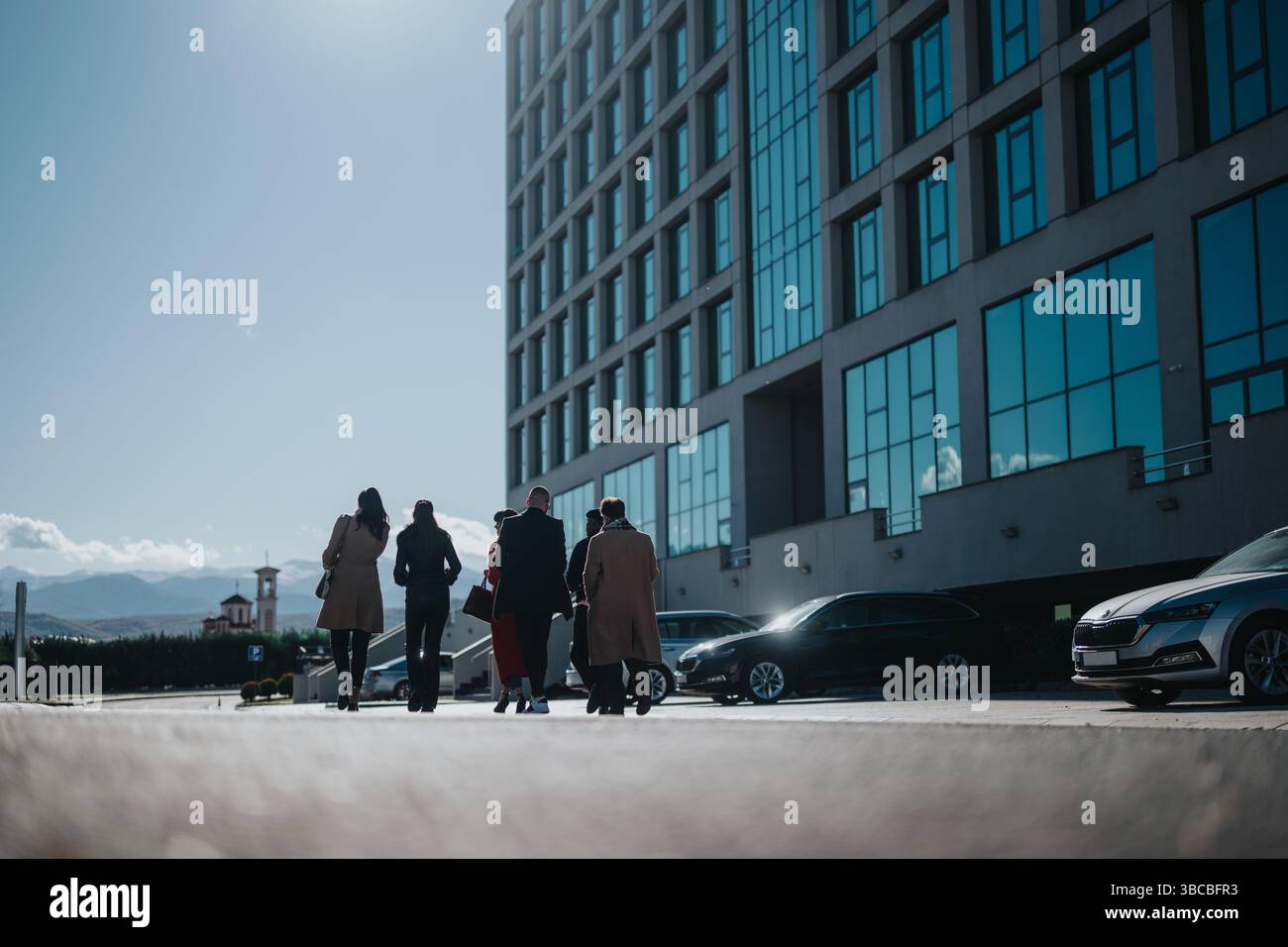 Group of people outside an office building on a clear sunny day Stock ...