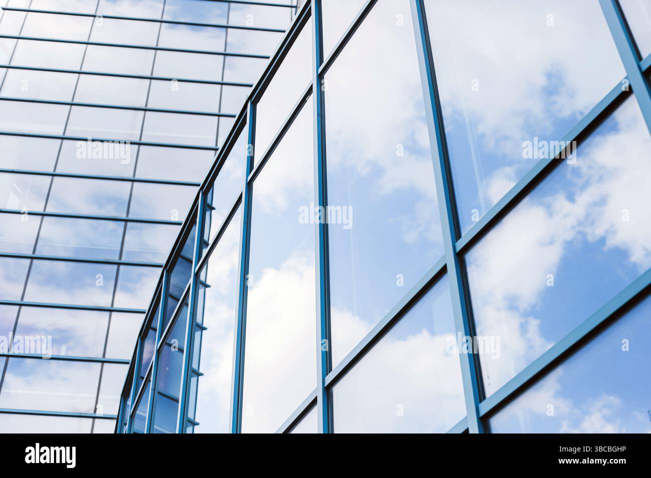 Modern glass building architecture. Blue sky reflection in windows ...