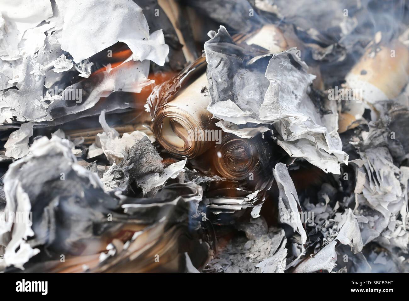 Burned newspapers and paper. Rolled pages turned into ashes. Fire ...