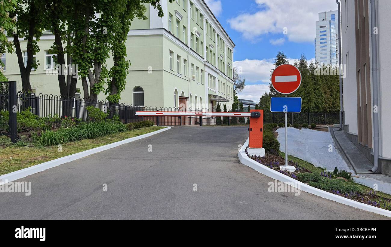 Closed barrier gate and no entry traffic sign positioned on an asphalt ...