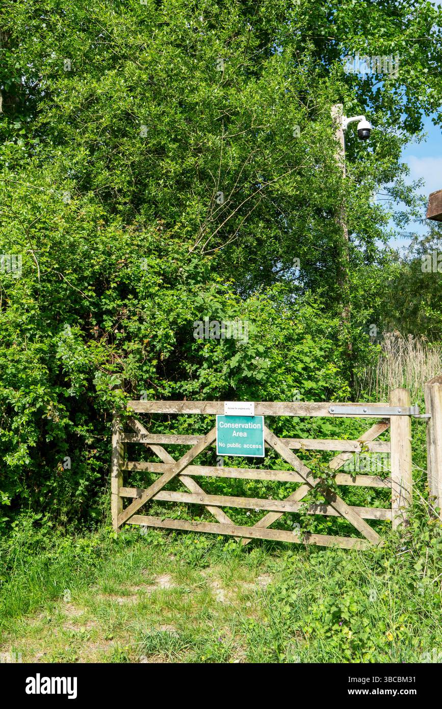 Conservation area sign on a five bar wooden gate Stock Photo - Alamy