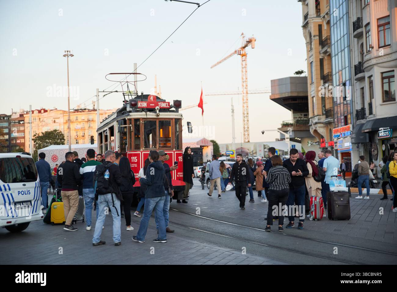 Istanbul's iconic red tram on bustling Istiklal Street at dusk. Crowds ...