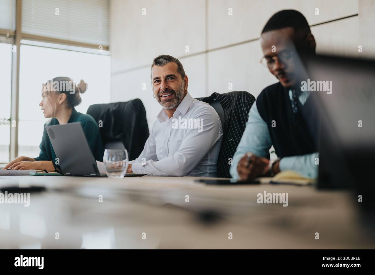 Multicultural team engaged in a collaborative business meeting Stock ...