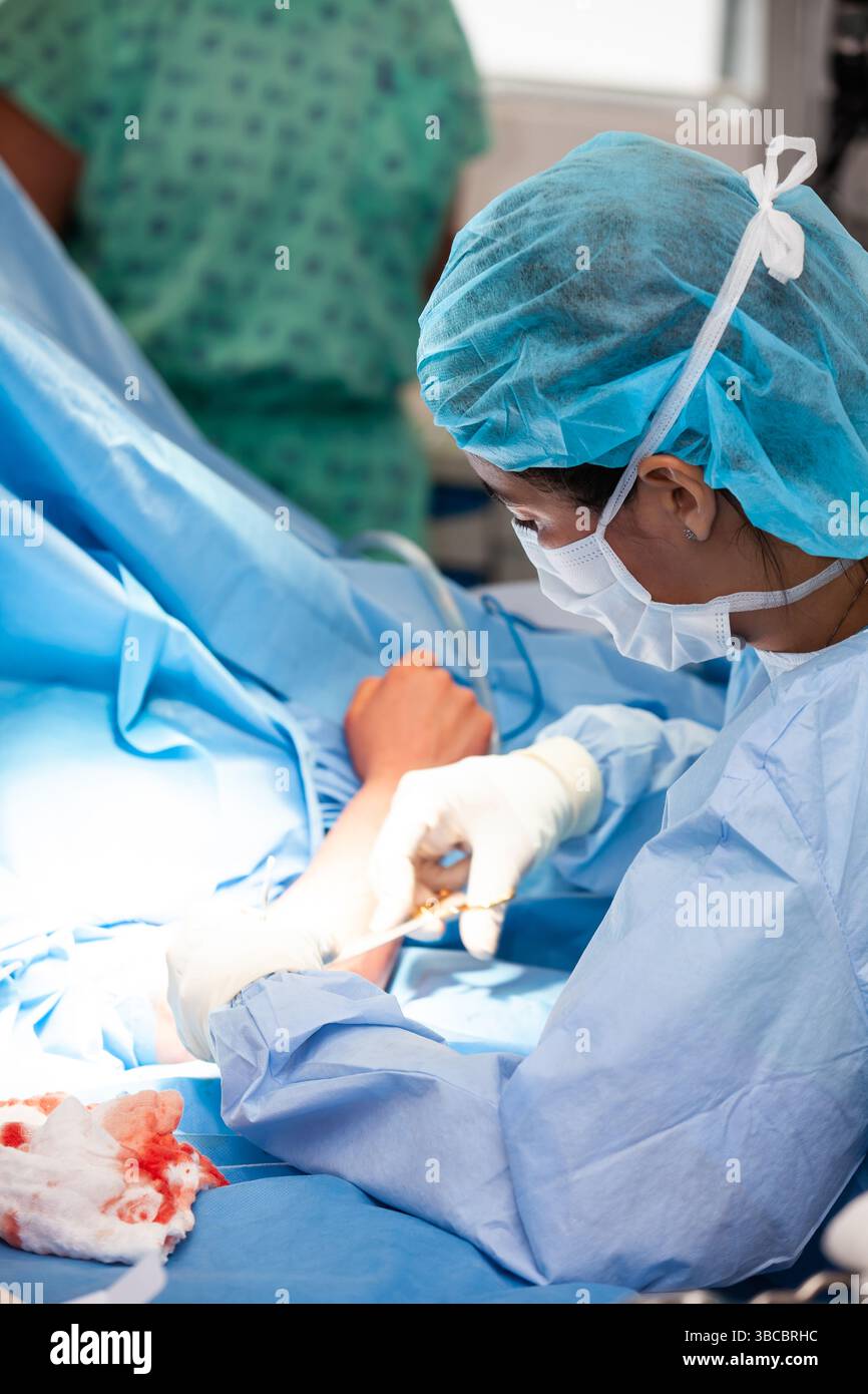 Female doctor performing a surgery. Orthopedic surgeon. Surgery and ...