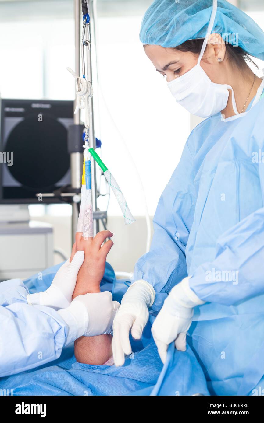 Arm of a patient ready for orthopedic surgery. Female doctor performing ...