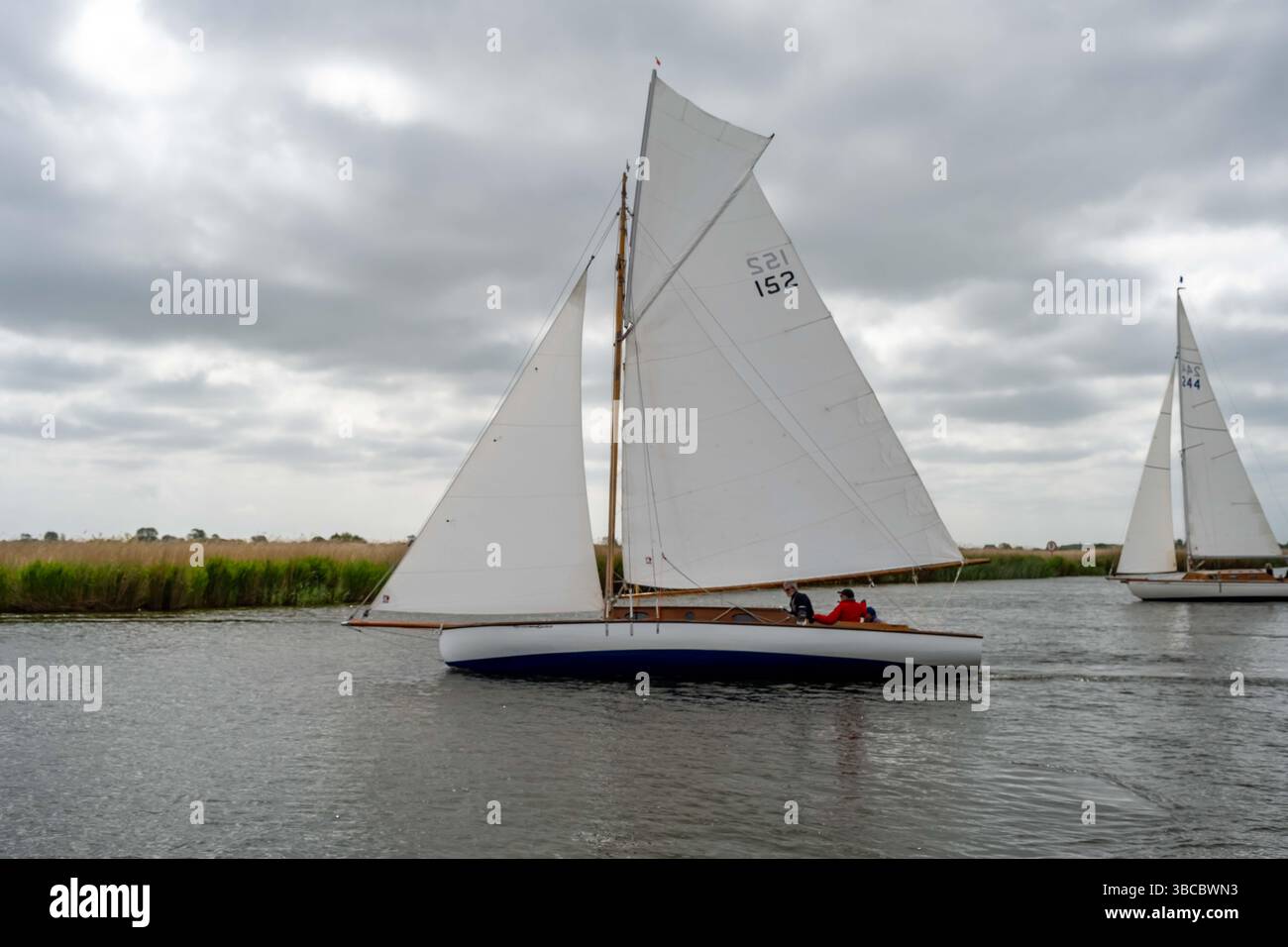 Upton, Norfolk, UK – May 18 2025. River cruiser tacking along the River ...
