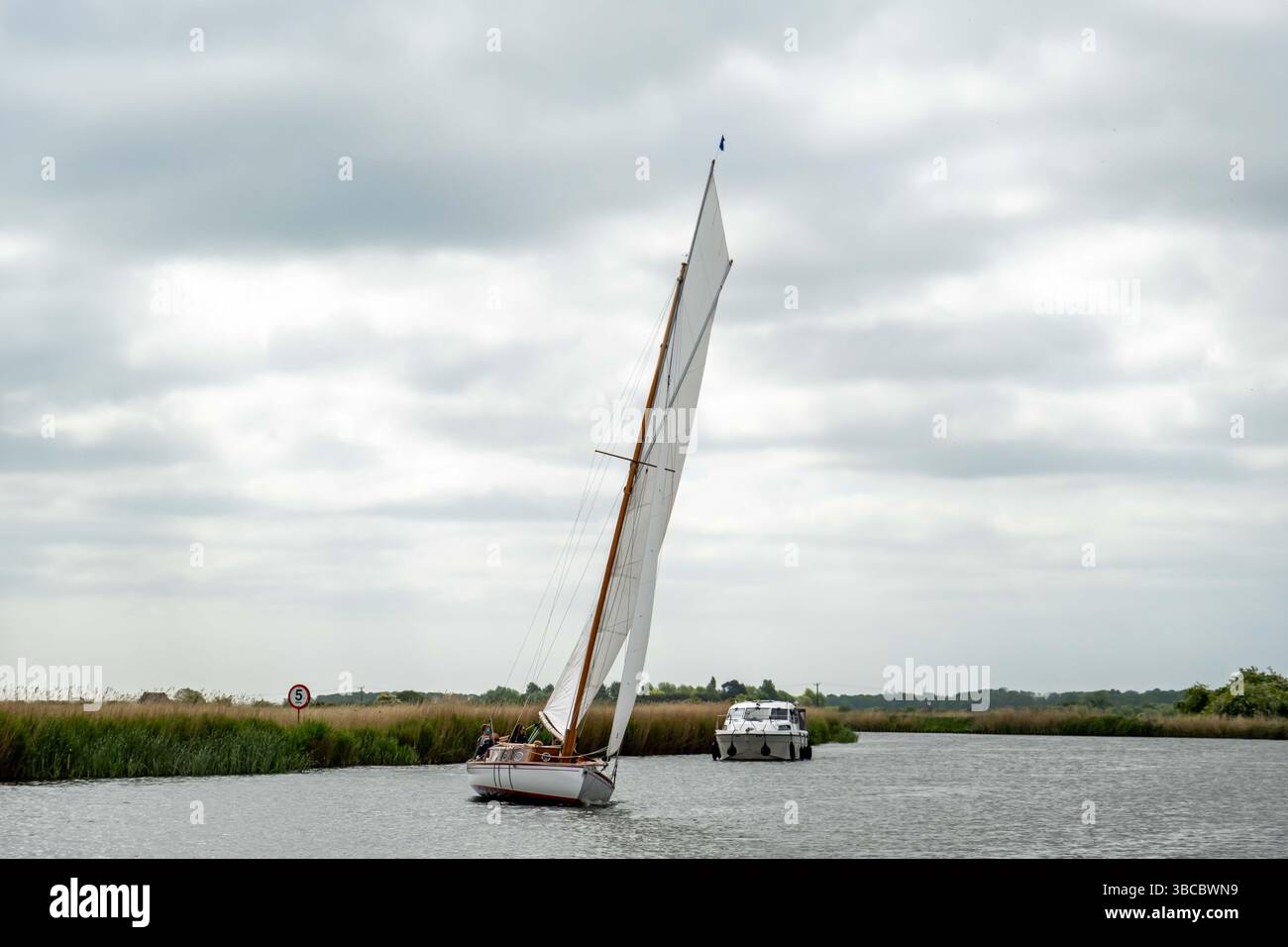 Upton, Norfolk, UK – May 18 2025. River cruiser tacking along the River ...