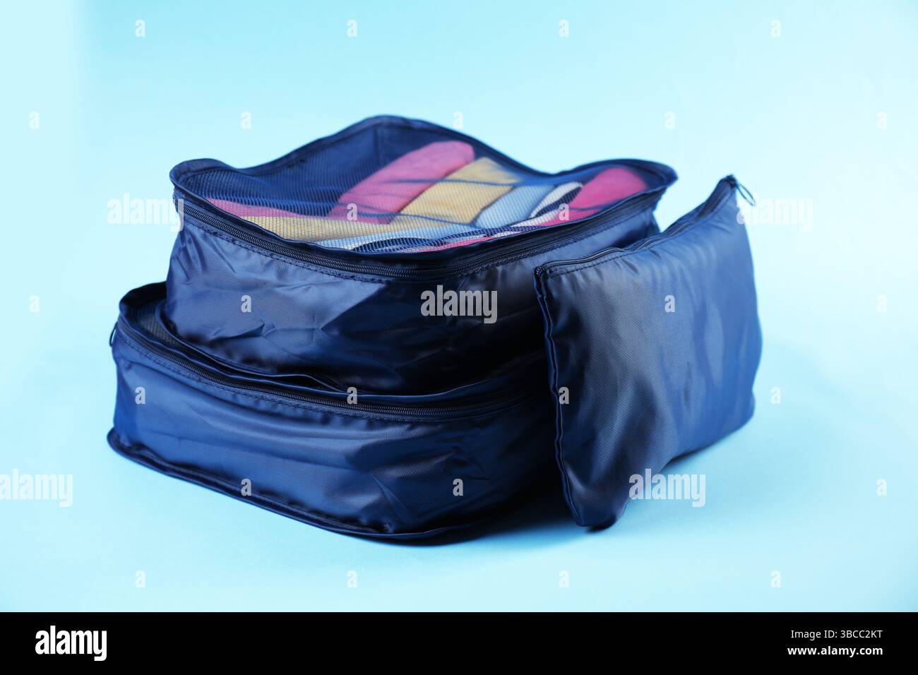 Packing cubes with clothes on light blue background, closeup Stock ...
