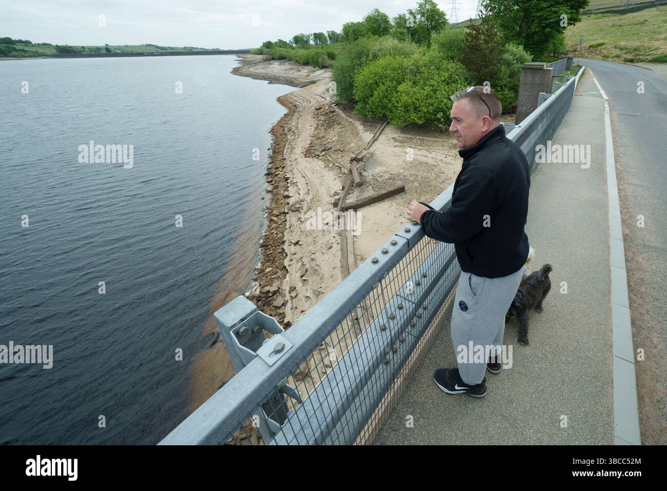 A member of the public looks from a bridge at Baitings Reservoir in ...