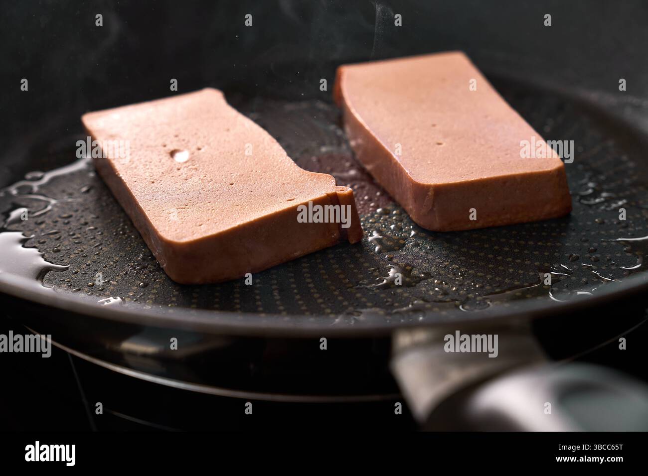 Bavaria, Germany - 19 May 2025: Two slices of vegan Leberkäse fried in ...